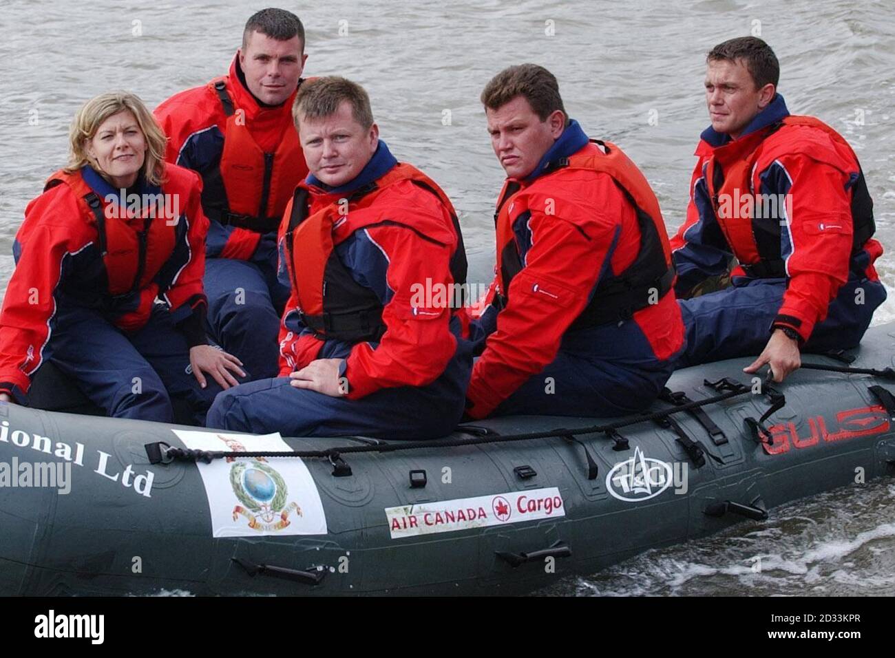 A team of Royal Marines, Royal Navy and a civilian exercise in a dinghy ...
