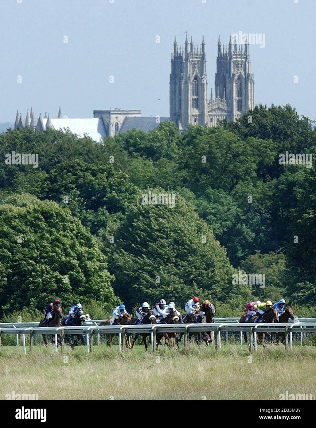 Jockeys race beverley minster background peaks over trees hi-res stock ...
