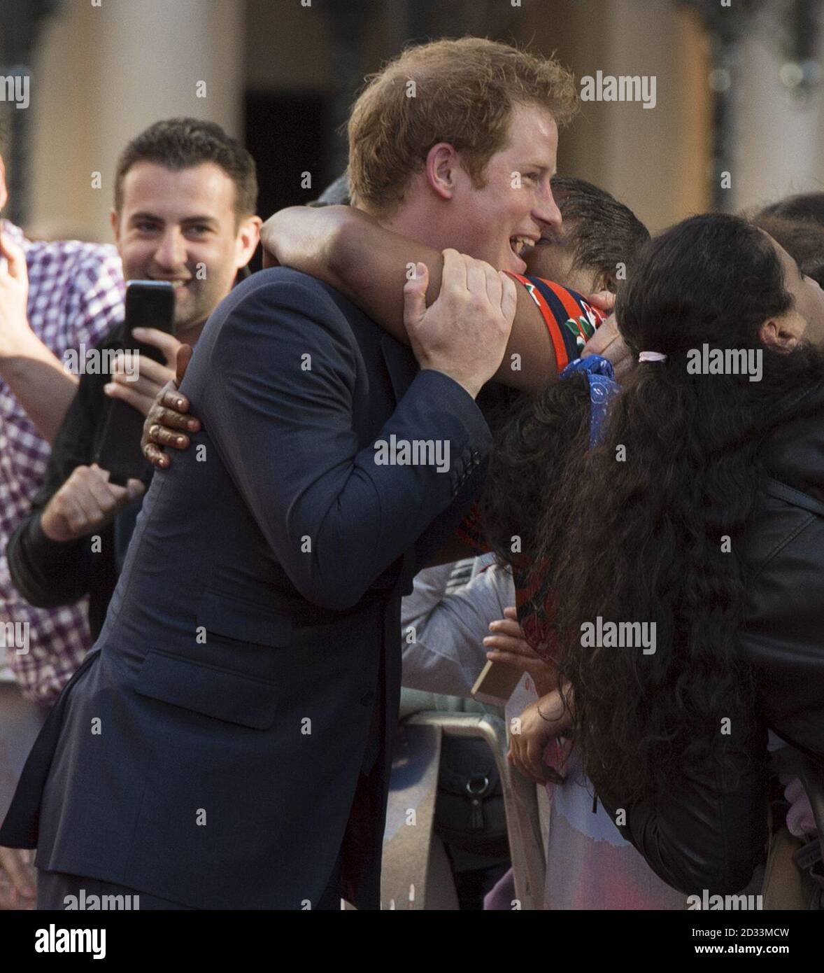 Prince Harry receives a hug from a fan as he attends the 50th ...