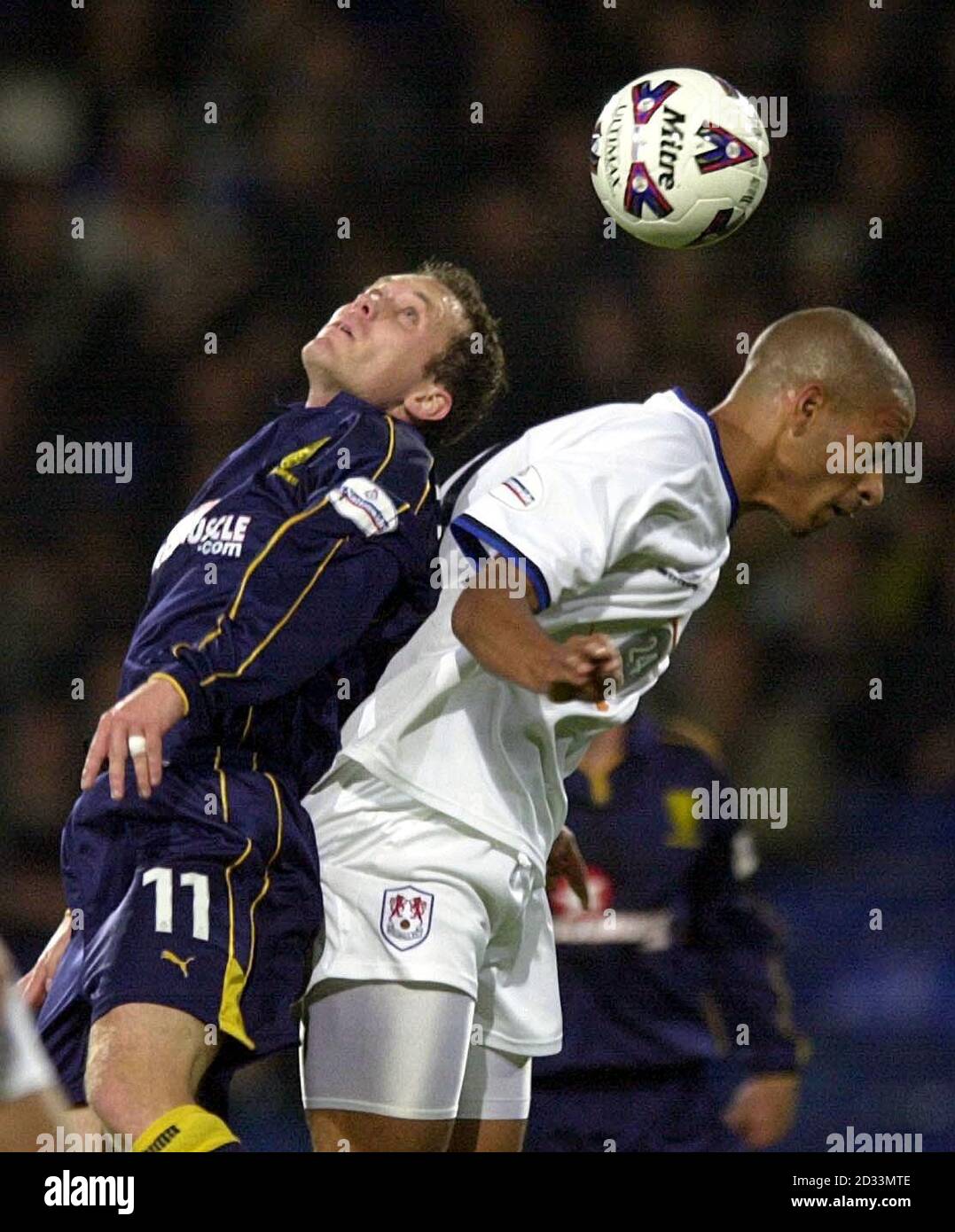 Wimbledon's Kevin Cooper (left) and Millwall's Steven Reid jump high ...