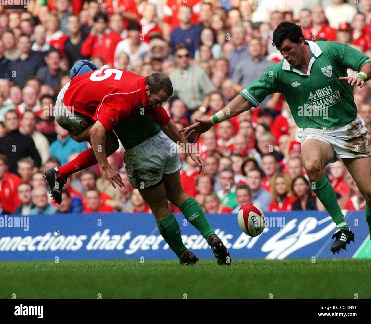 Wales' Kevin Morgan is stopped in his tracks by a crunching tackle from ...