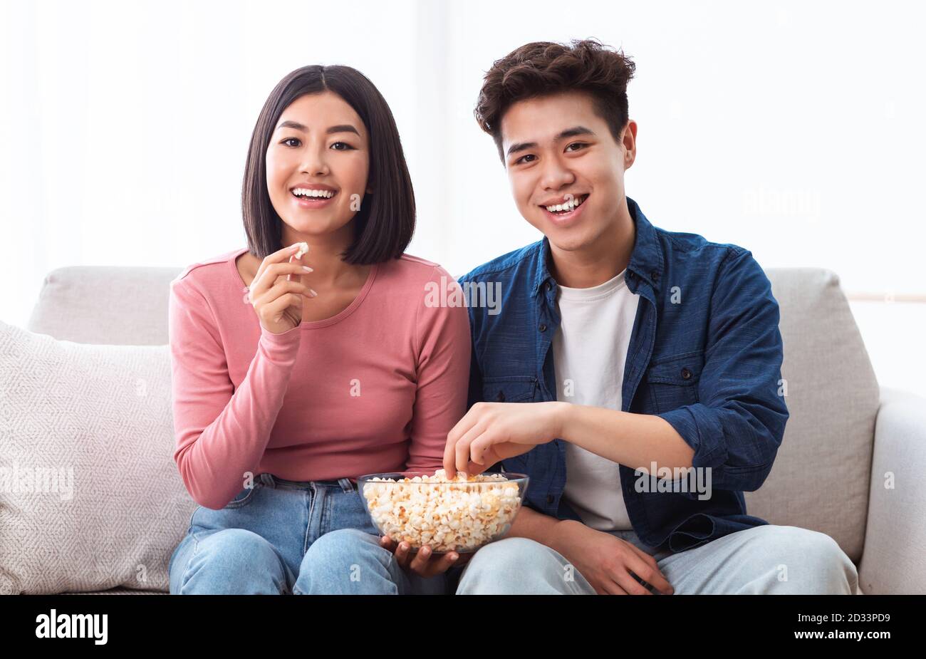 Korean Boyfriend And Girlfriend Watching Television Sitting On Sofa ...