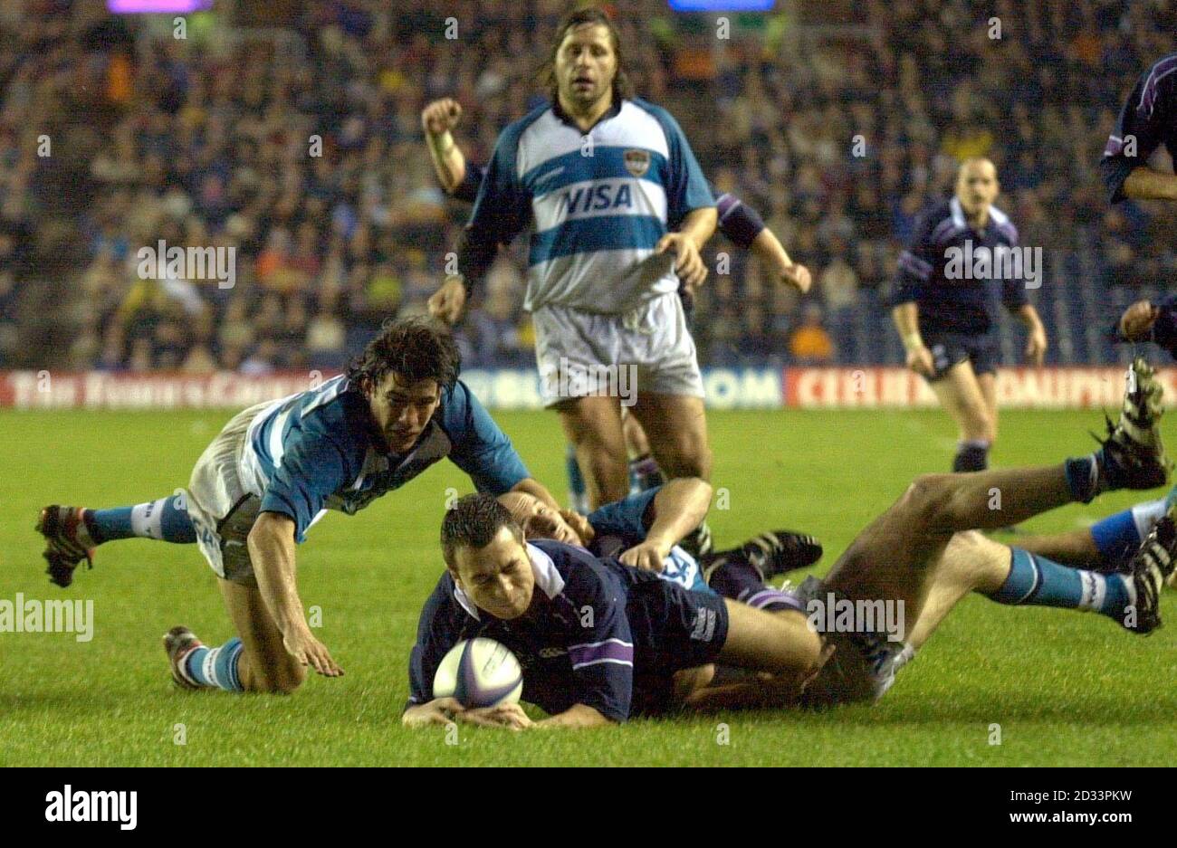 Scotland's Derek Lee scores a try despite the efforts of Argentina's ...
