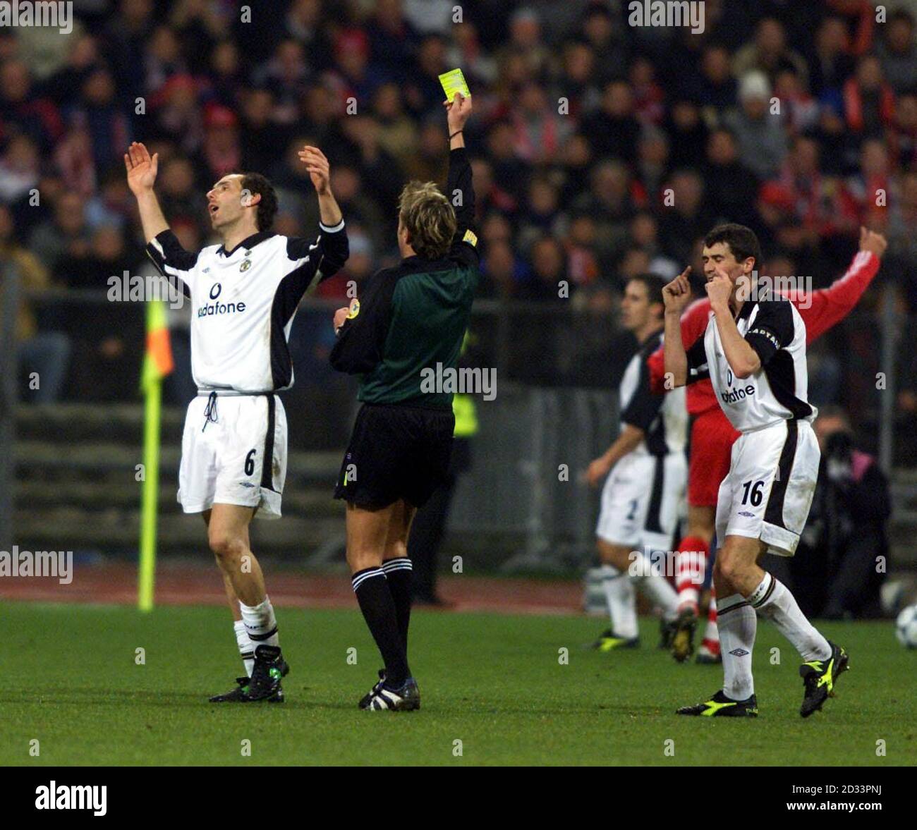 Manchester United's Laurent Blanc (left) is shown the yellow card by ...
