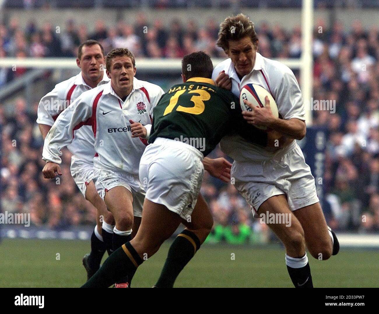 England's Will Greenwood is tackled by South Africa's Trevor Halstead ...