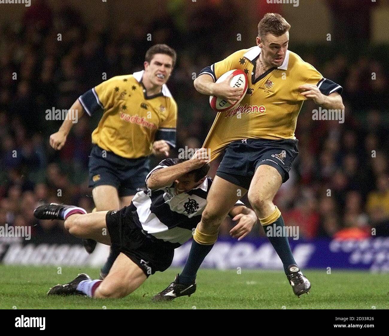 Australia's Chris Latham (right) is tackled by Stephane Glas of the ...