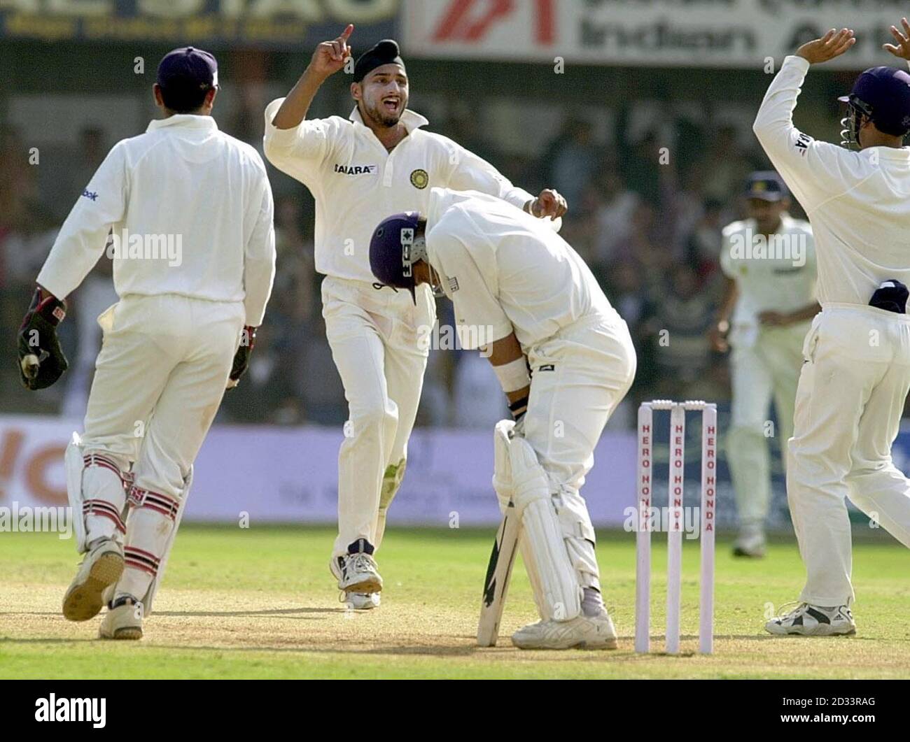 Indian bowler Harbhajan Singh (second left) celebrates the wicket of ...