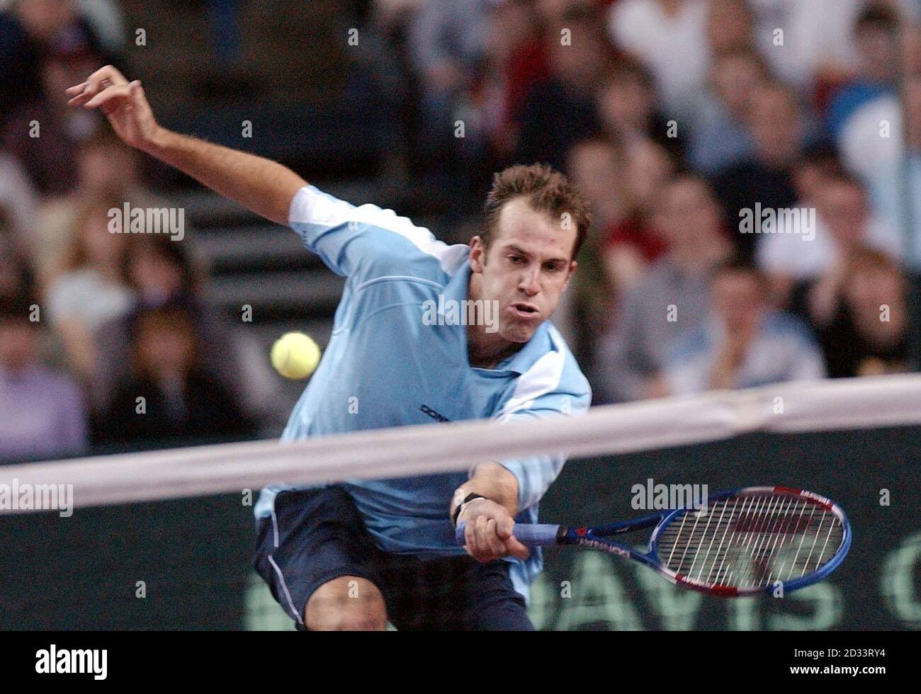 Greg Rusedski plays a fine low volley to win a point from Thomas ...