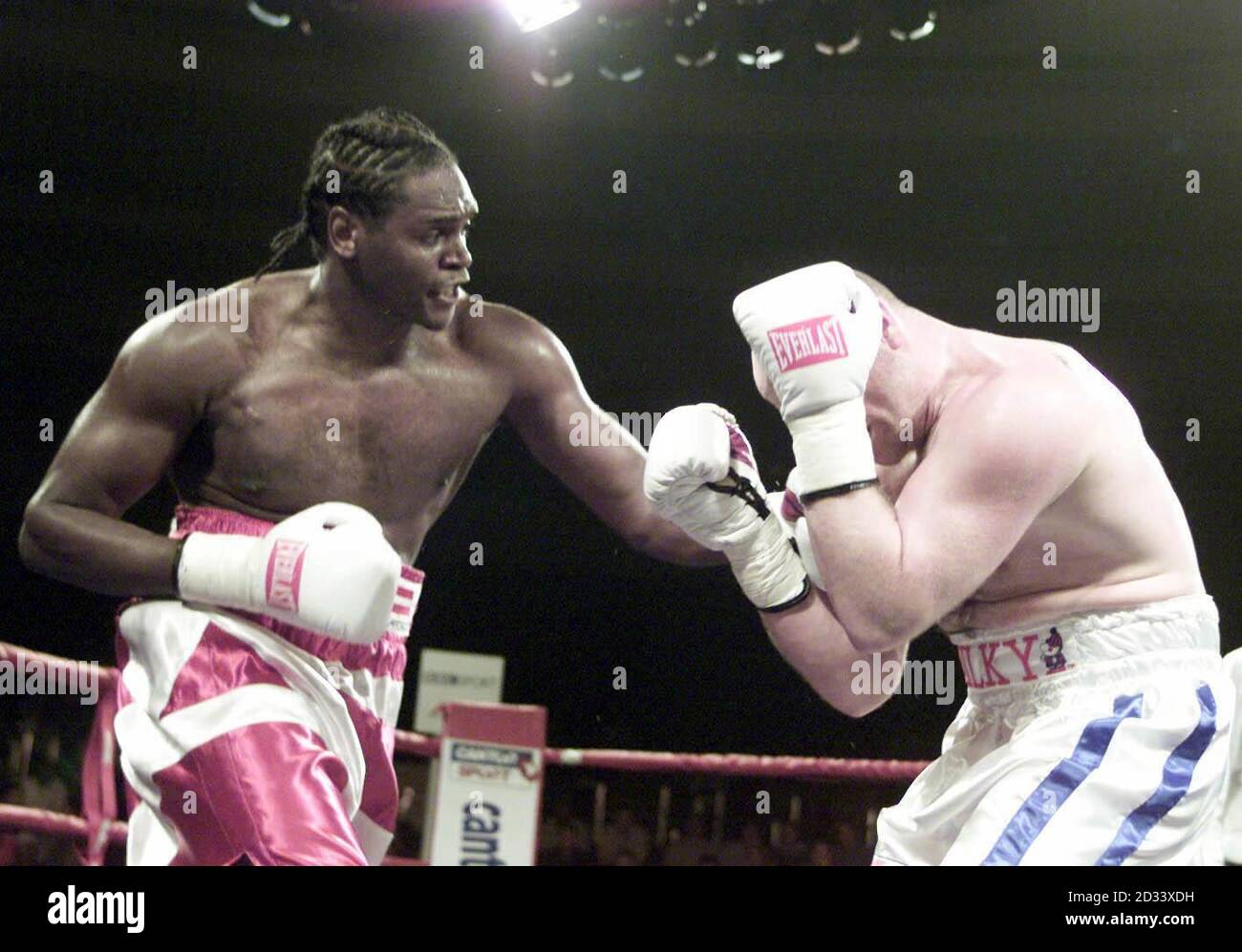 Audley Harrison (left) punishes opponent Dominic Negus with a left hook ...