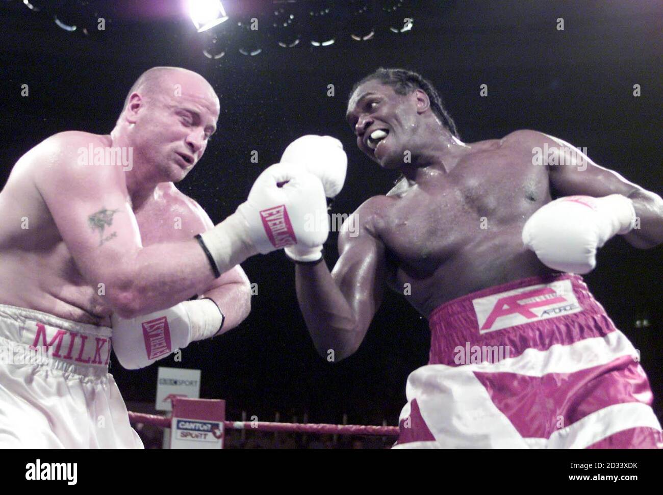 Audley Harrison right) punishes opponent Dominic Negus with a blow to ...