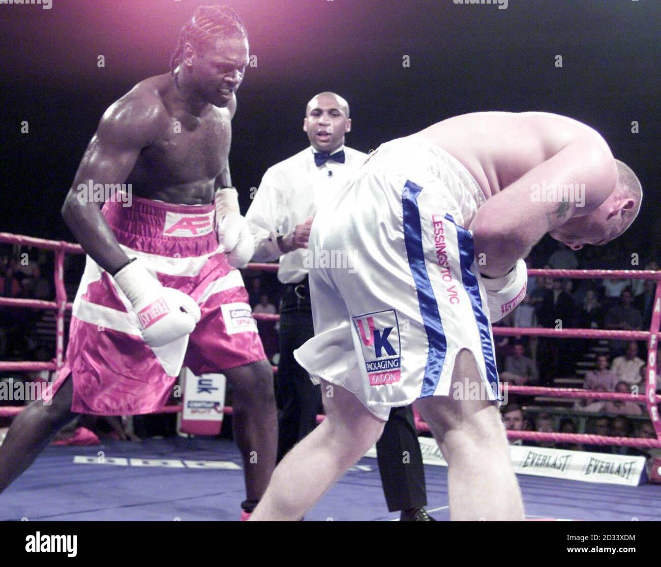 Audley Harrison (left) lands a low blow on opponent Dominic Negus ...