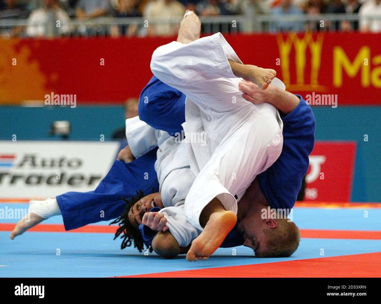 Wales's Luke Preston (blue) tangles with England's Thomas Cousins ...