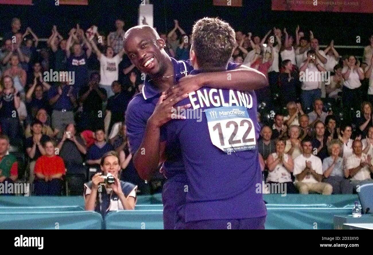 England's Gareth Herbert celebrates his gold medal with teammate Andrew ...