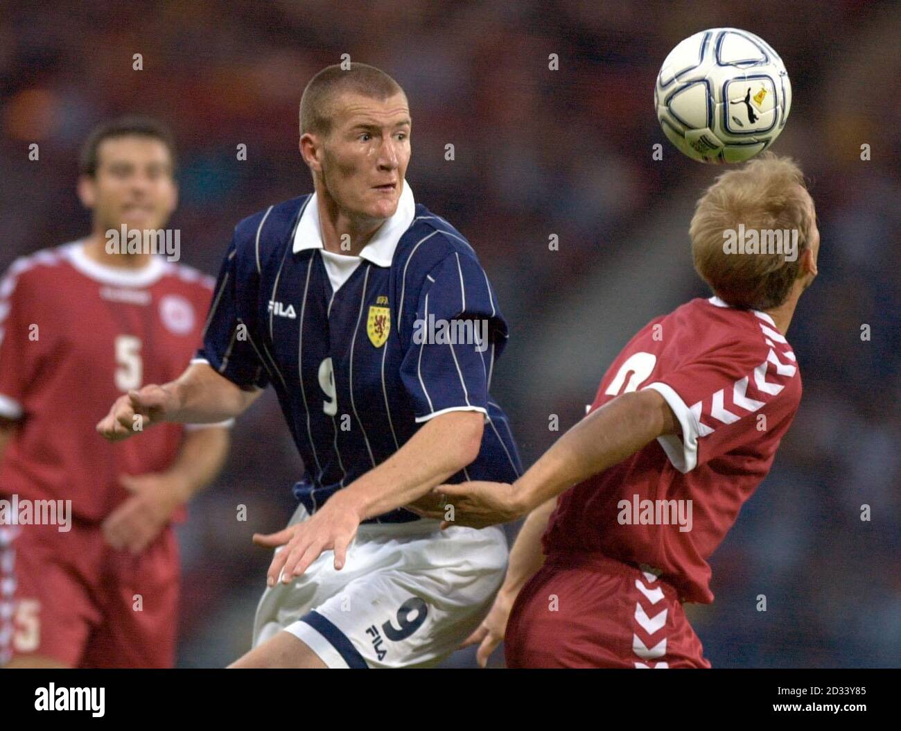 Scotland's Kevin Kyle heads the ball past Denmark's Rene Henriksen ...