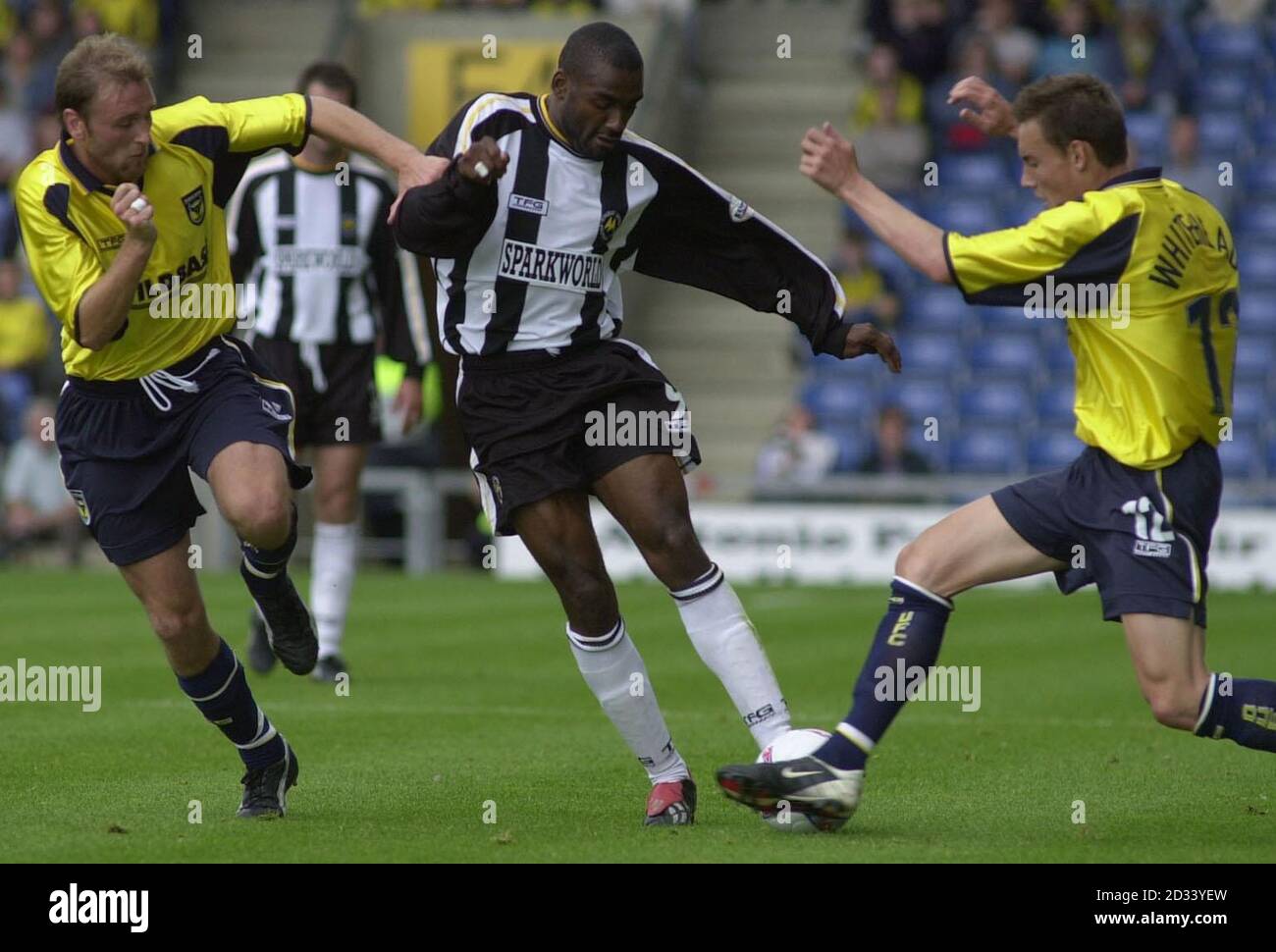 Torquay Untied's Tony Bedeau squeezes between Oxford's David Oldfield ...