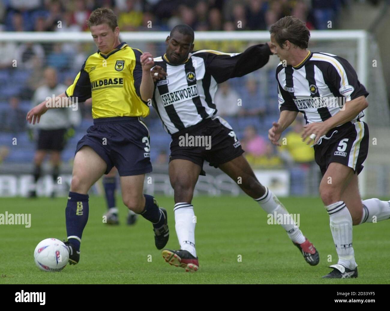 Torquay United's Tony Bedeau (centre) tussles with Paul Powell of ...