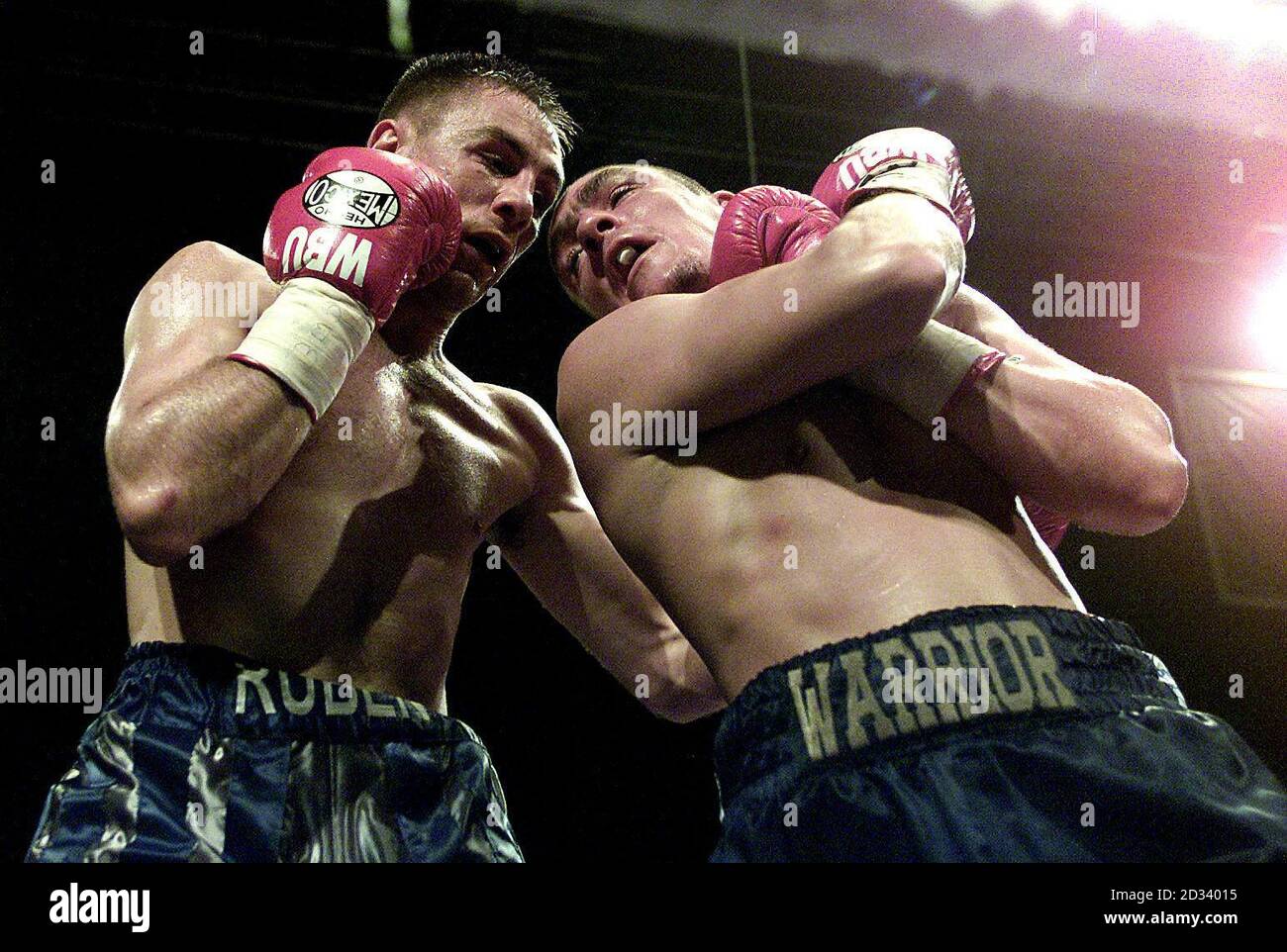 Challenger Anthony Farnell (right) throws a right uppercut to Champion ...