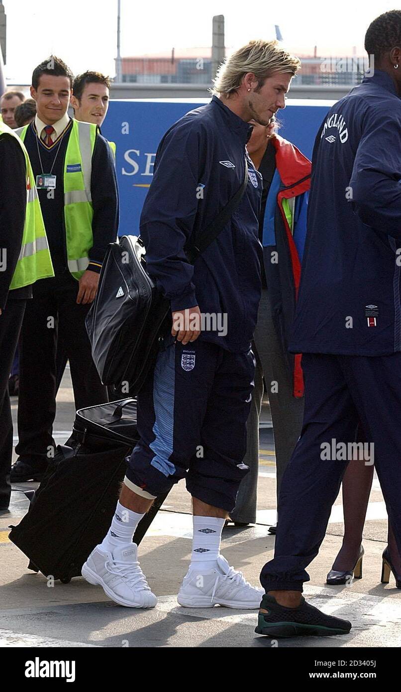 England captain David Beckham boards the team plane at Luton Airport ...