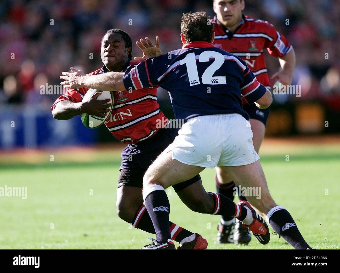 Gloucester's Marcel Garvey (left) is challenged by Munster's Rob ...