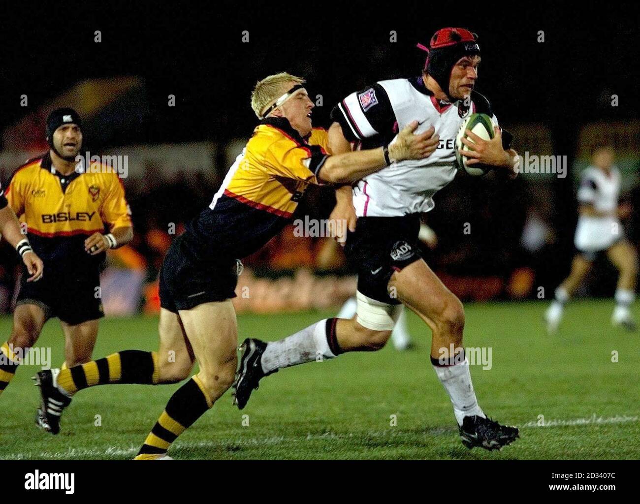 Toulouse's Fabien Pelous (second right) holds off the tackle from ...