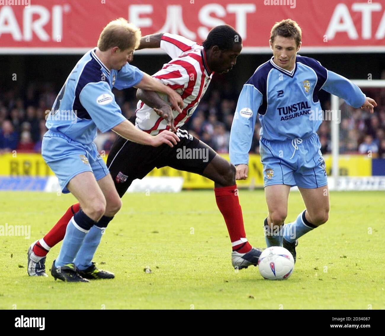 Brentford's Mark McCammon steers the ball between Port Vale's Ian ...