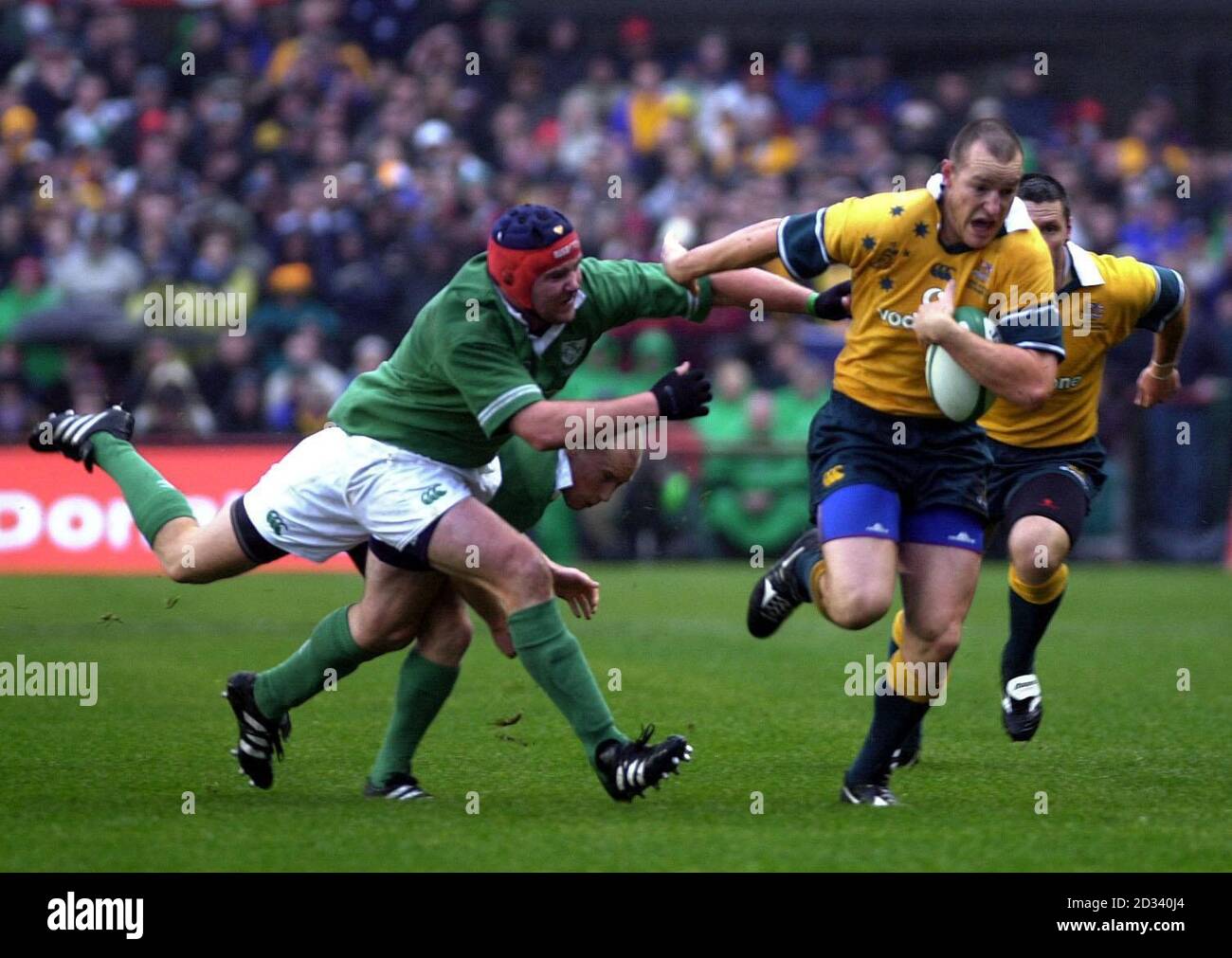 Ireland's Anthony Foley tackles Australia's Stirling Mortlock (right ...