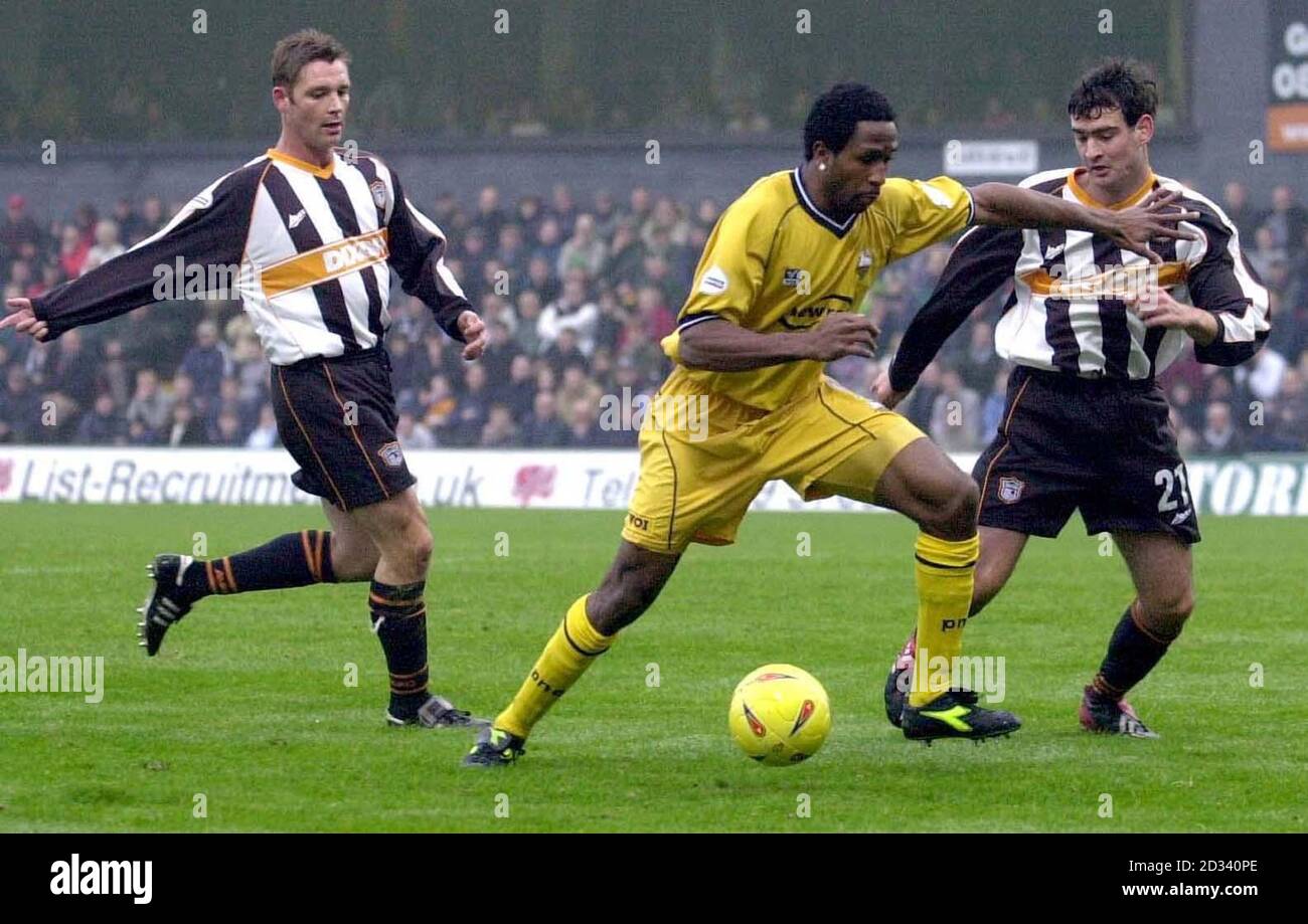 Preston's Richard Fuller (centre) comes under pressure from Grimsby's ...