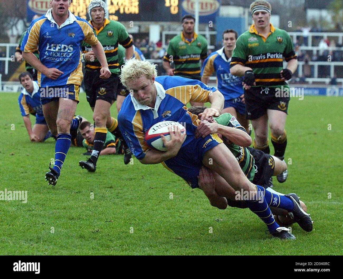 Leeds Tykes' Dan Scarbrough (front) dives over to score the second try ...