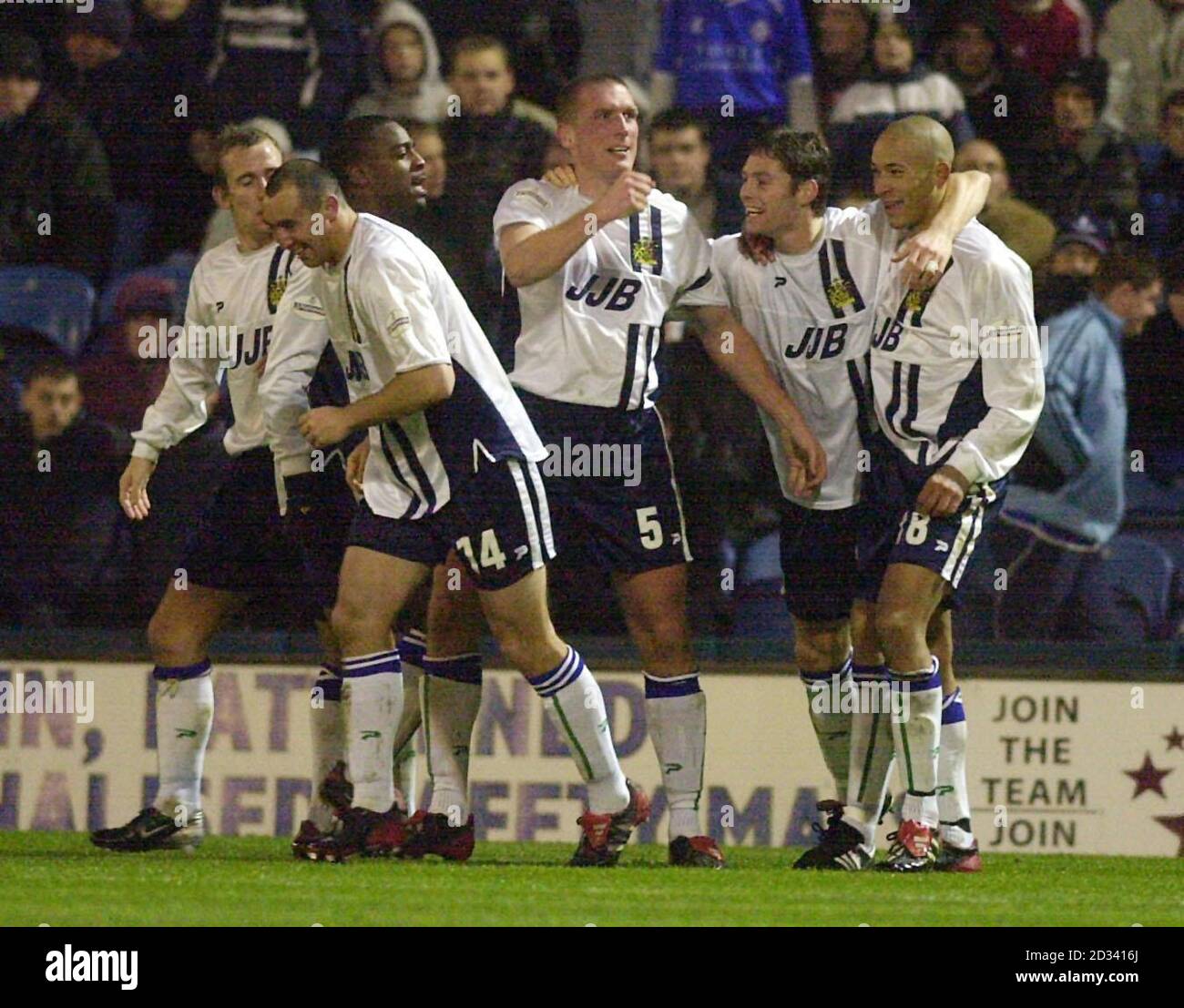 Jason De Vos (centre) of Wigan celebrates with team-mates after scoring ...