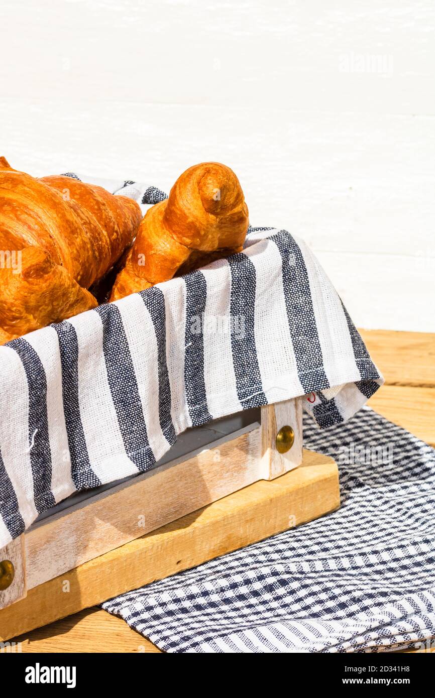Fresh croissant, puff pastry and buttered french croissant on wooden ...