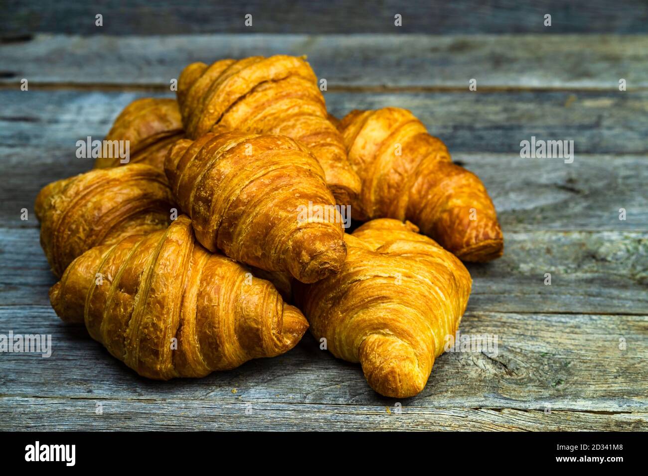 Delicious, fresh croissants isolated on wooden board. French breakfast ...