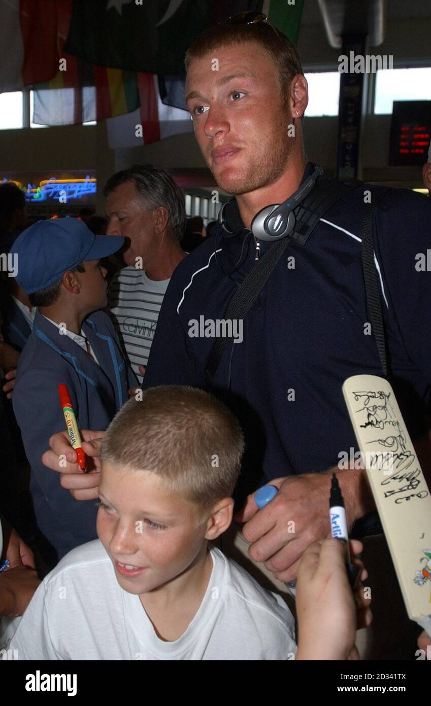 England cricketer Andrew Flintoff signs an autograph for a young South ...