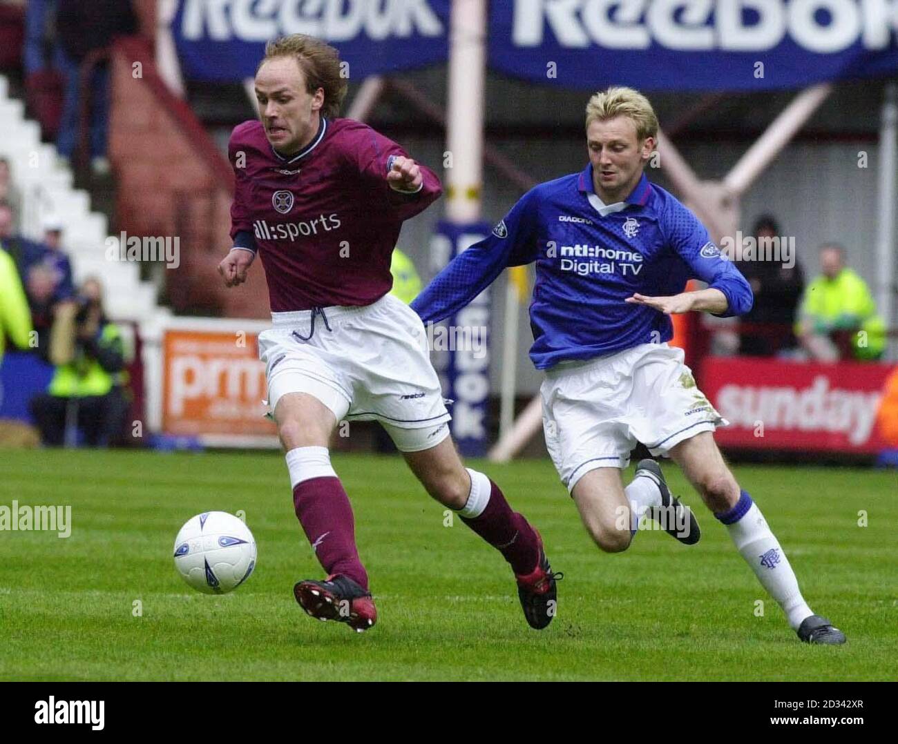 Rangers player Stephen Hughes chases Hearts' Neil Macfarlane during ...