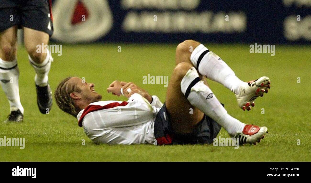 England's David Beckham nurses his arm, causing his substitution in the ...