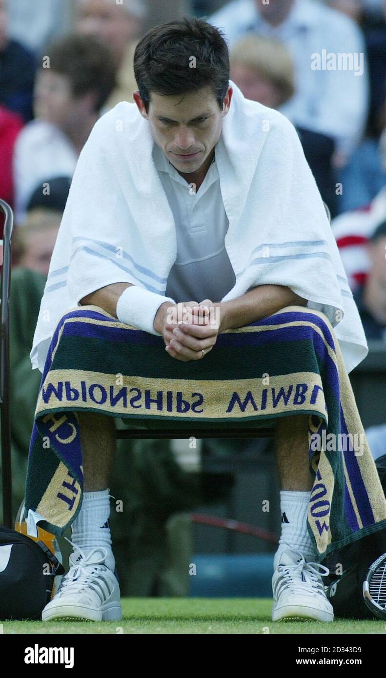 EDITORIAL USE ONLY, NO MOBILE PHONE USE : Britain's Tim Henman sits ...