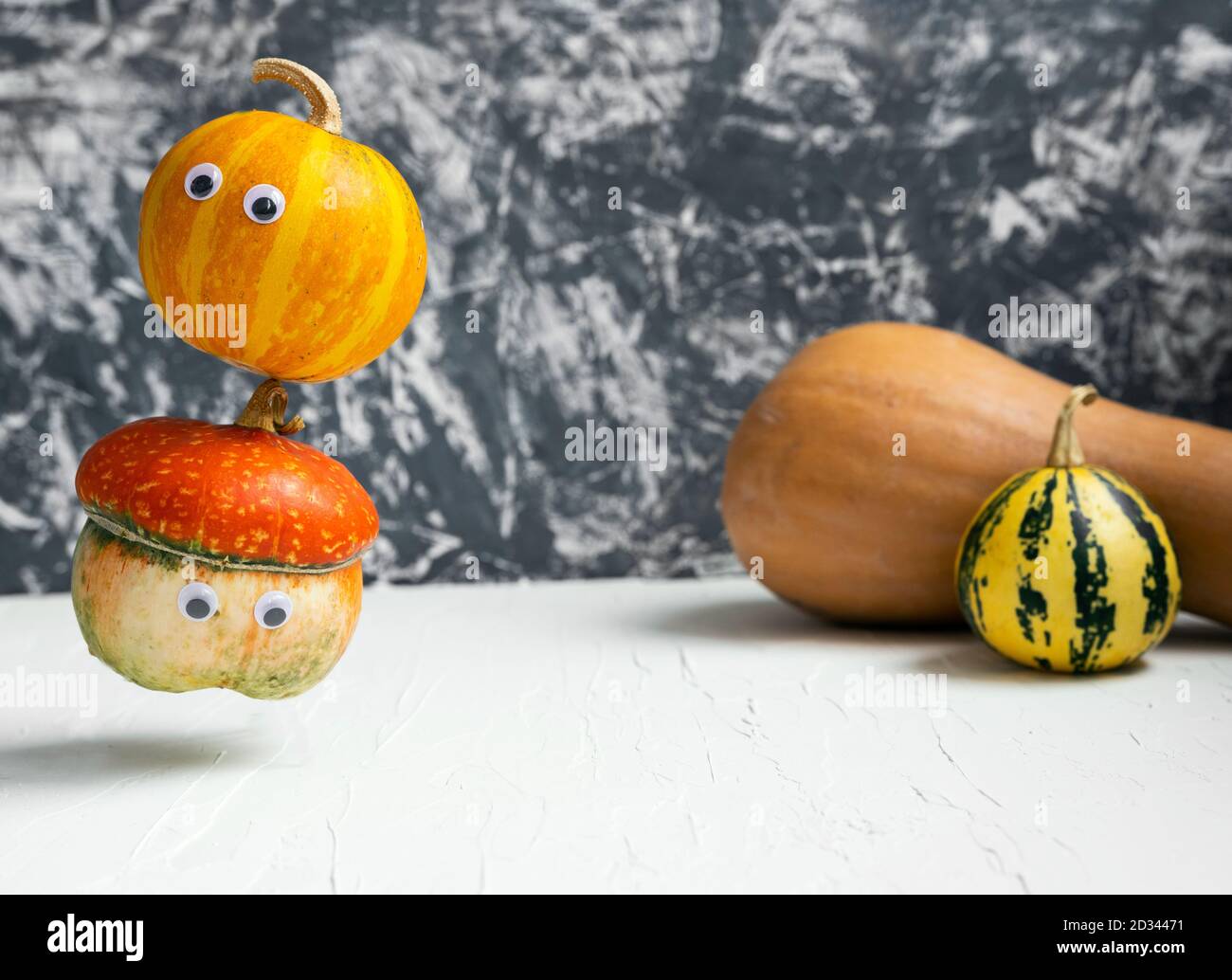 Closeup Photo of Funny small flying pumpkins with eyes on white and ...