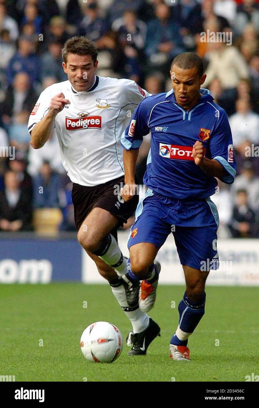 Derby County's Jeff Kenna (left) is held off by Watford's Danny Webber ...