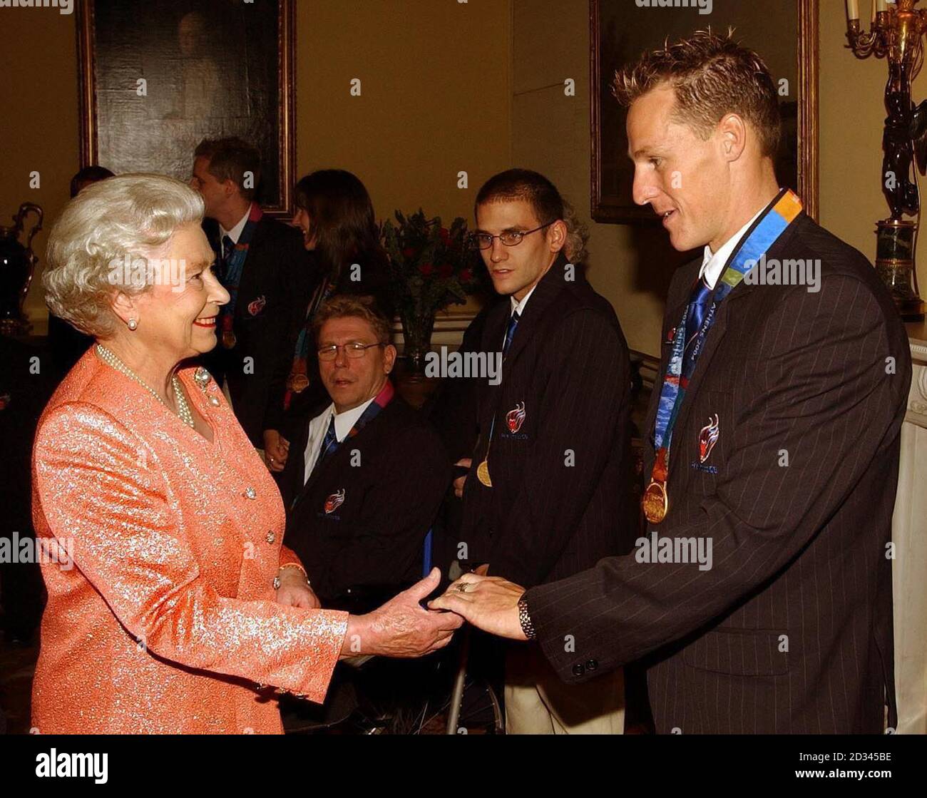 Britain's Queen Elizabeth II (left) shakes hands with 800m Paralympic ...