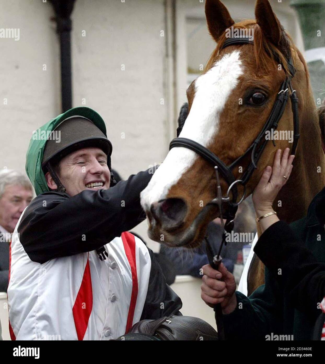 Jockey Peter Buchanan congratulates Forest Gunner after they won the ...