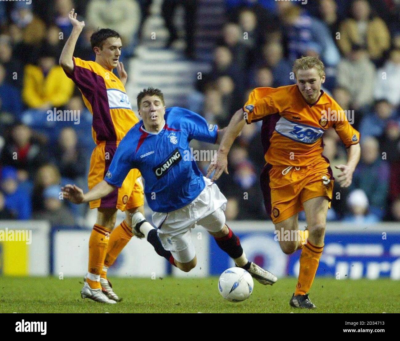Motherwell's Richard Foran (right) gets away from Rangers' Gregory ...