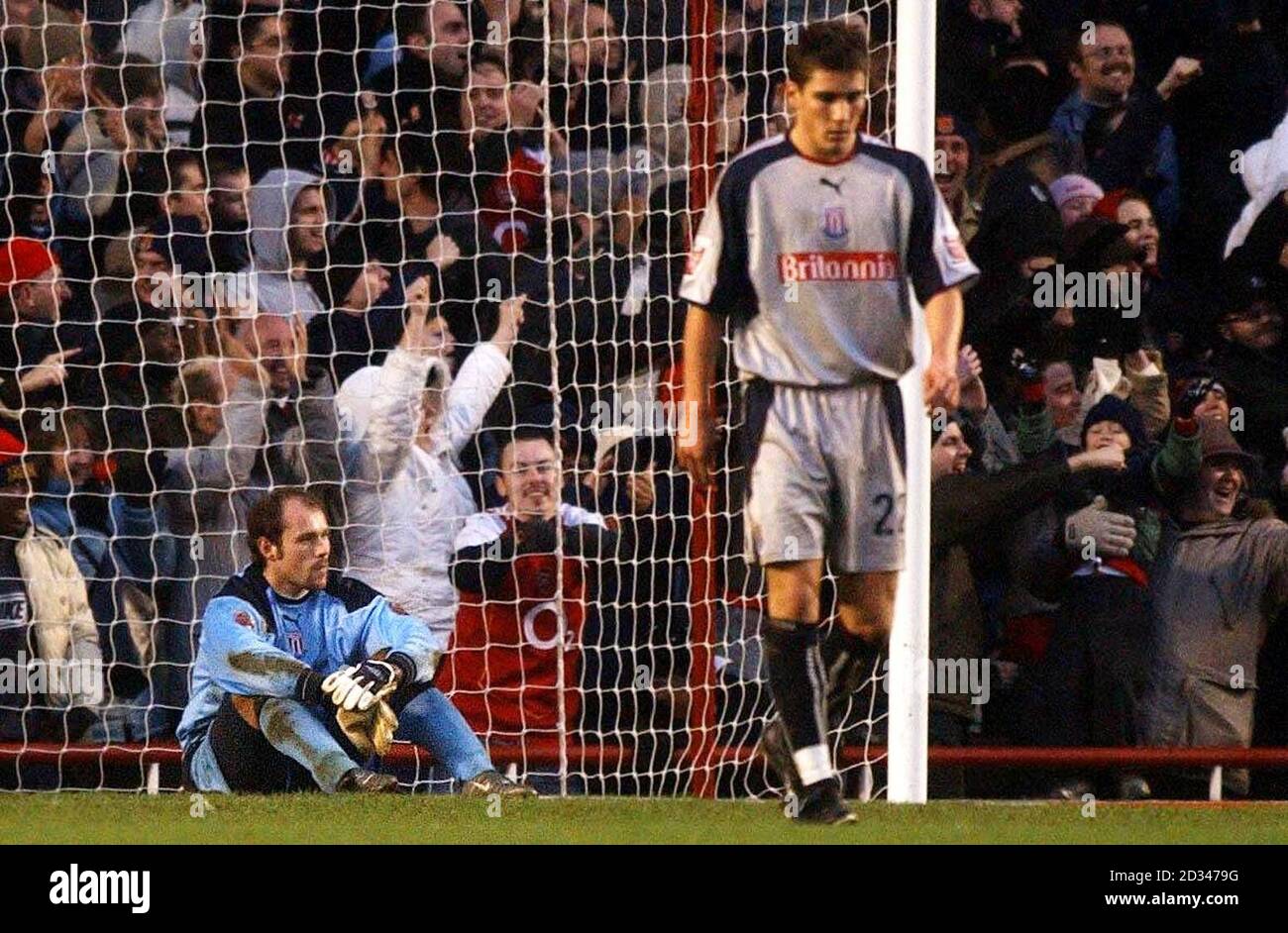 Stoke goalkeeper Steve Simonsen sits dejected following the second goal ...