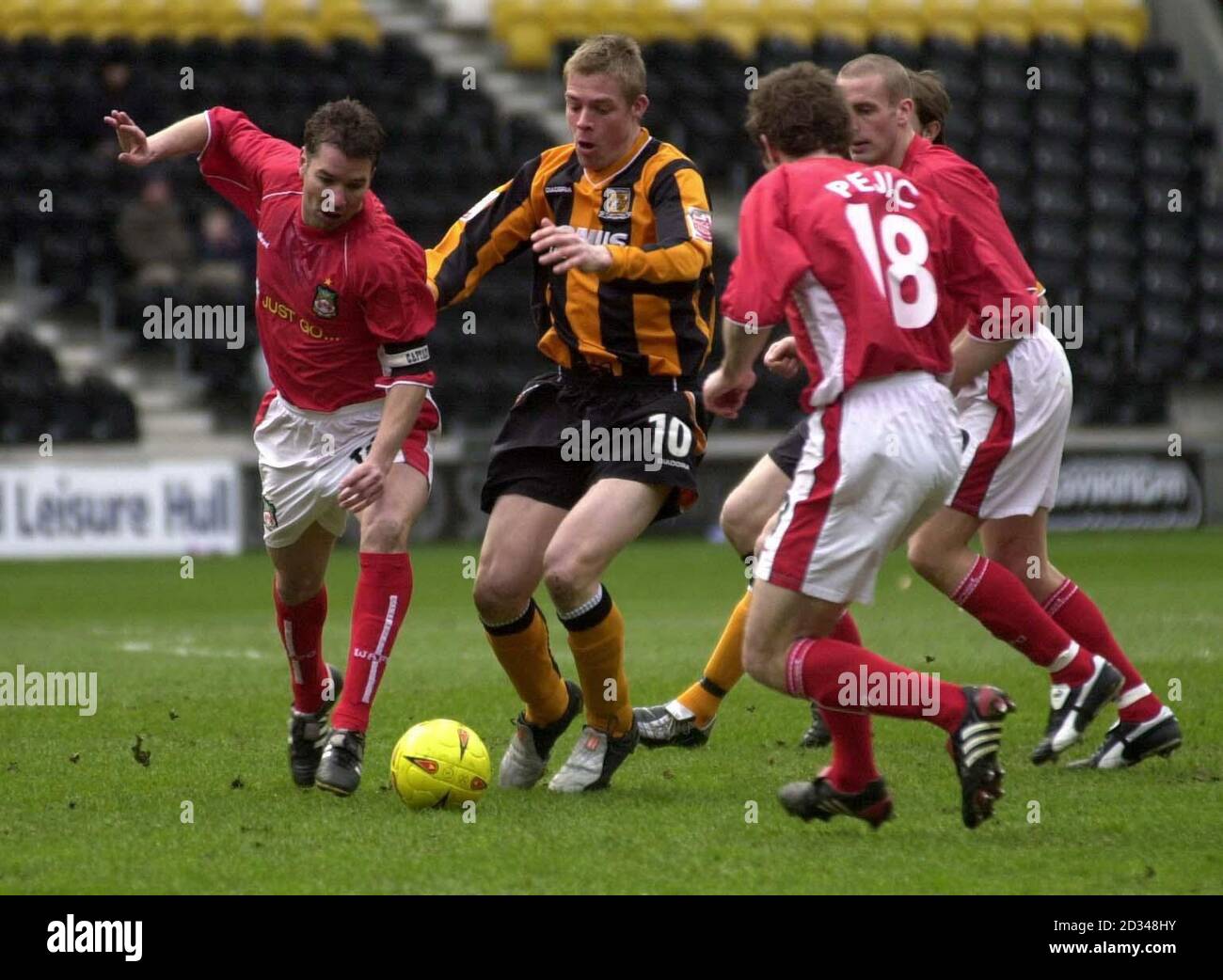 Hull City's Danny Allsopp (C) takes on Wrexham's Darren Ferguson (L ...
