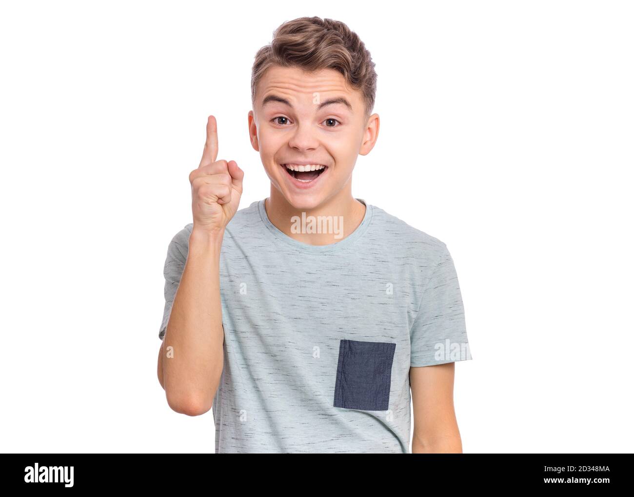 Cute teen boy pointing up, gesturing idea or doing number one gesture ...