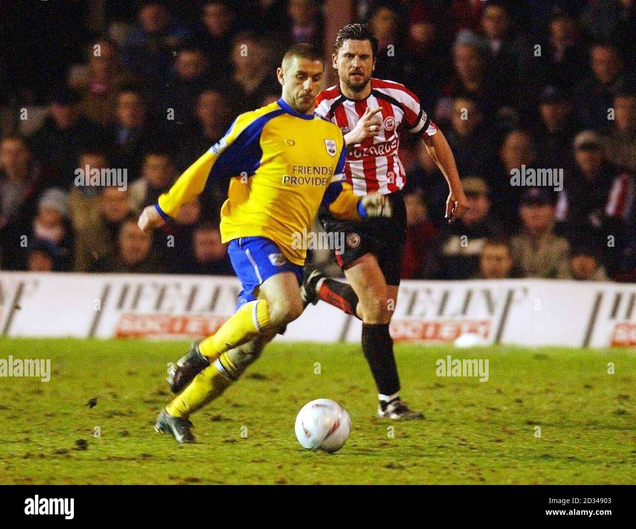 Southampton's Kevin Phillips (L) goes past Brentford's Stewart Talbot ...