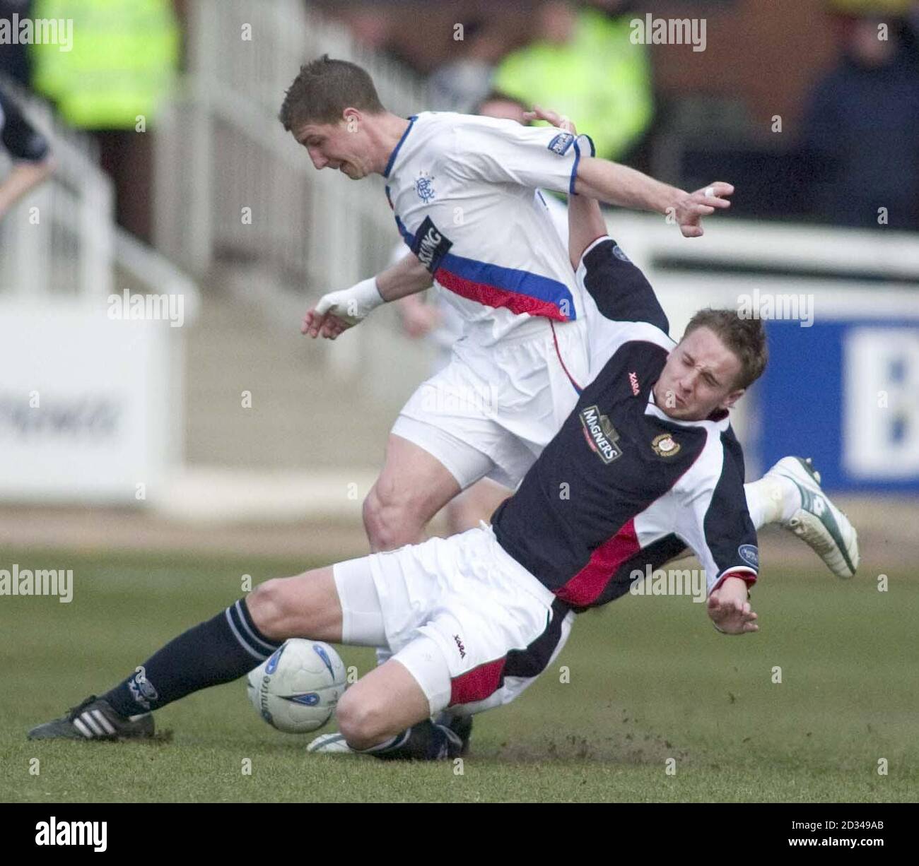 Rangers' Gregory Vignal (L) is tackled by Dundee's Tom McManus Stock ...