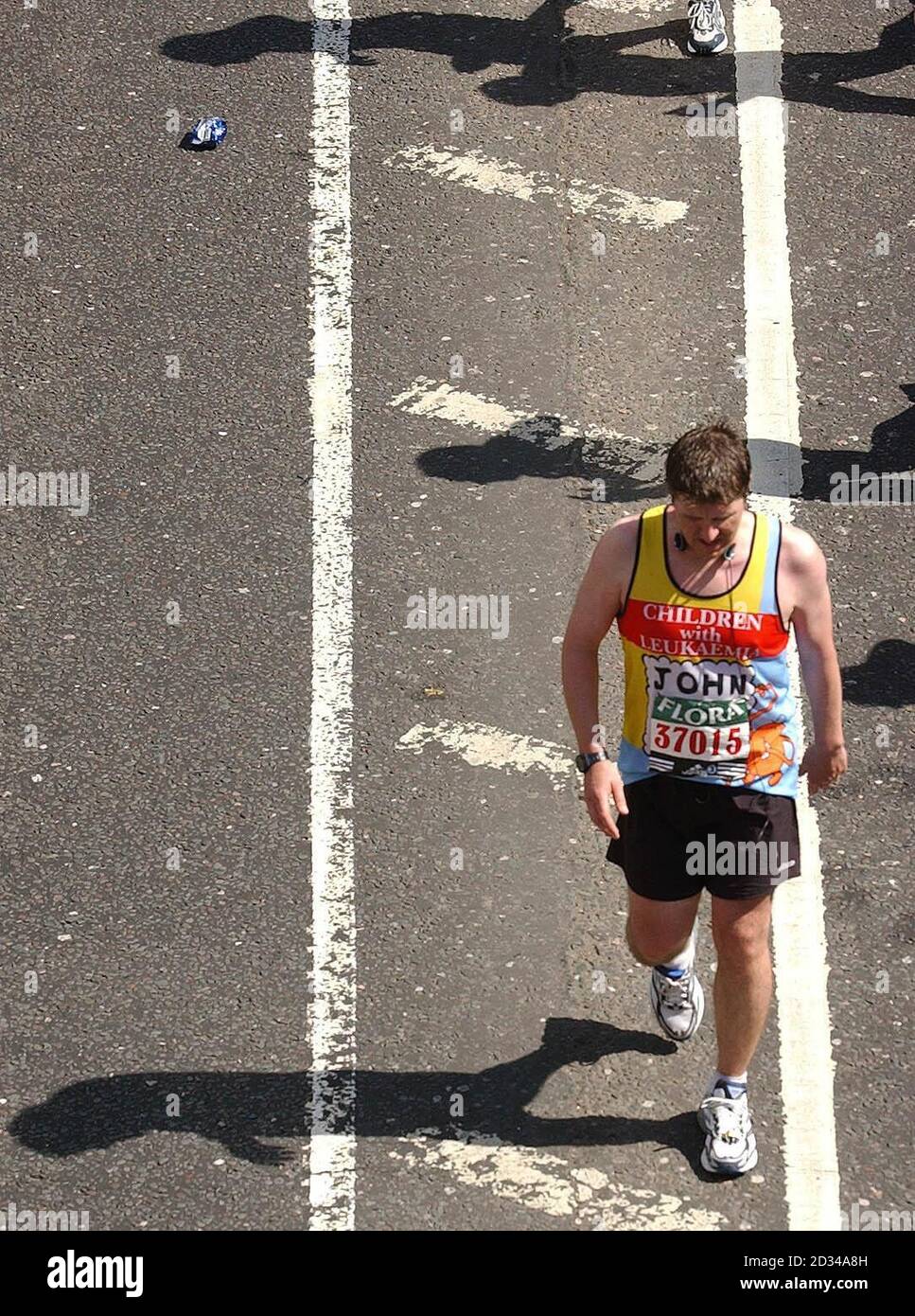 A tired looking runner walks the final stages Stock Photo - Alamy