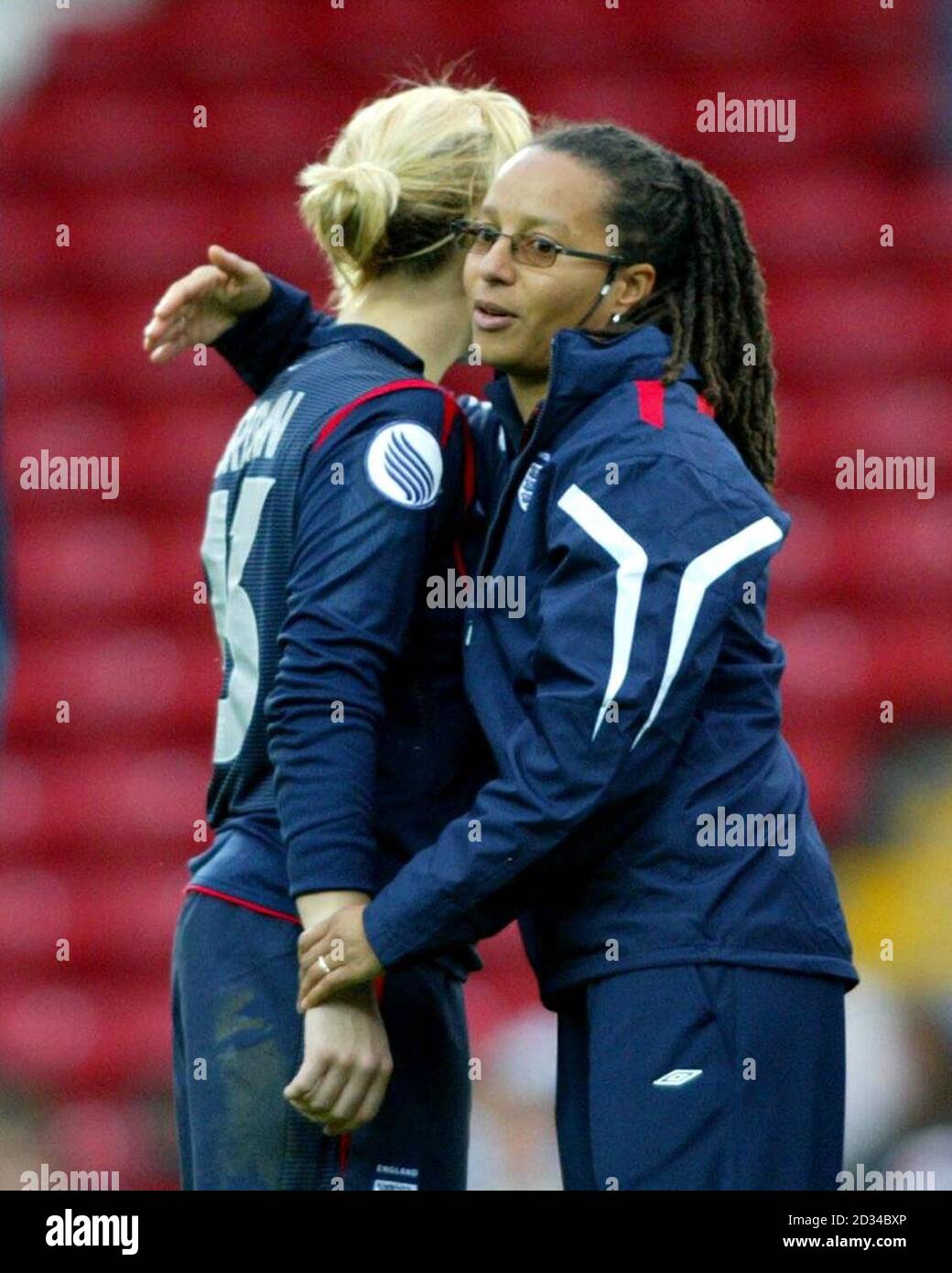 England manager Hope Powell (R) consoles goalkeeper Rachel Brown ...