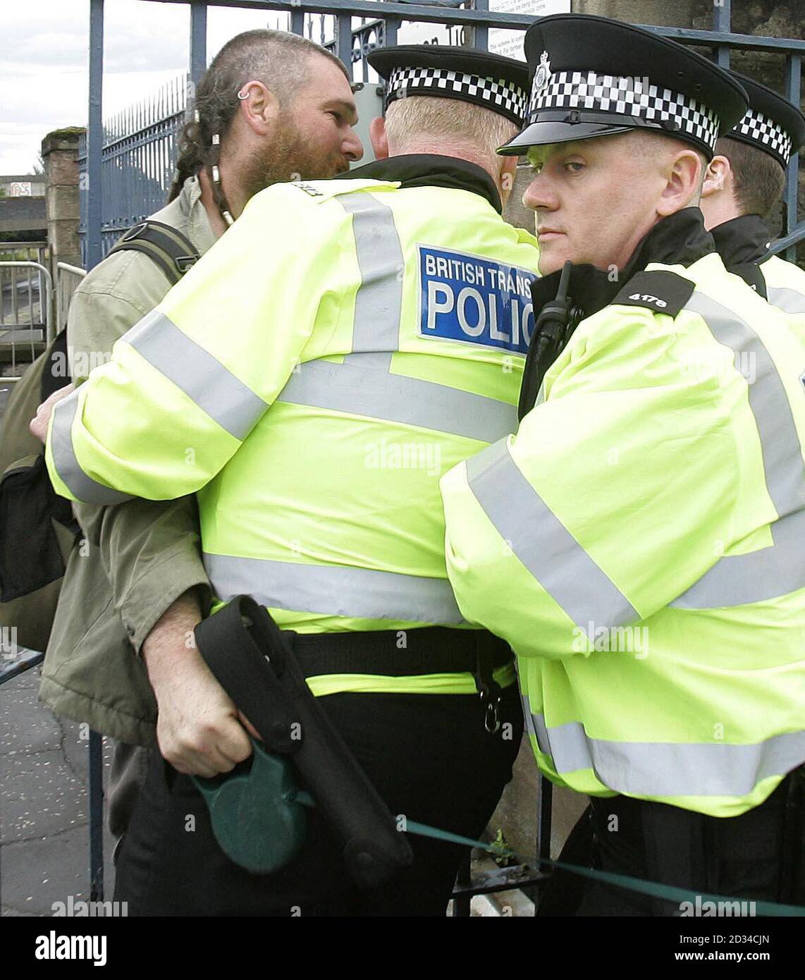 Police with a G8 activist Stock Photo - Alamy