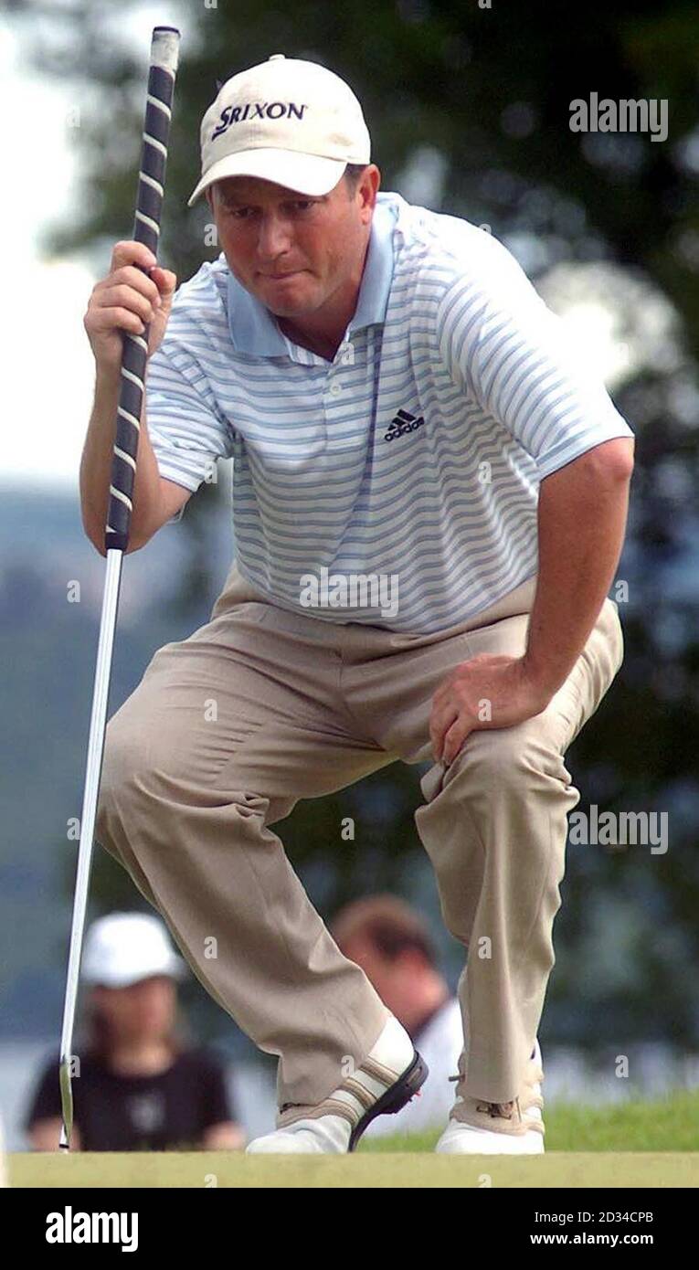 South Africa's Tim Clark studies the line of a putt on the first green ...
