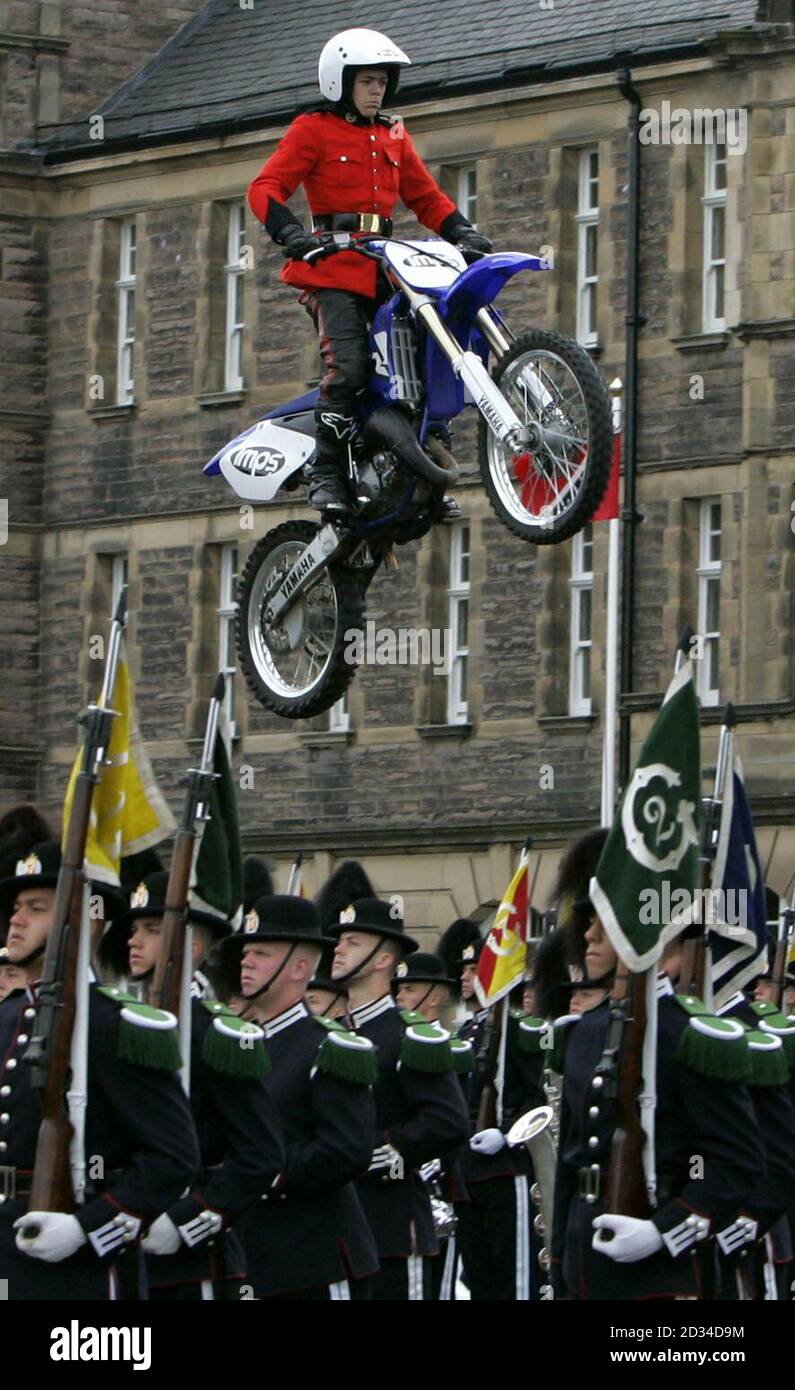 A member of the Imps Motorcycle display team jumps over the Guard of ...
